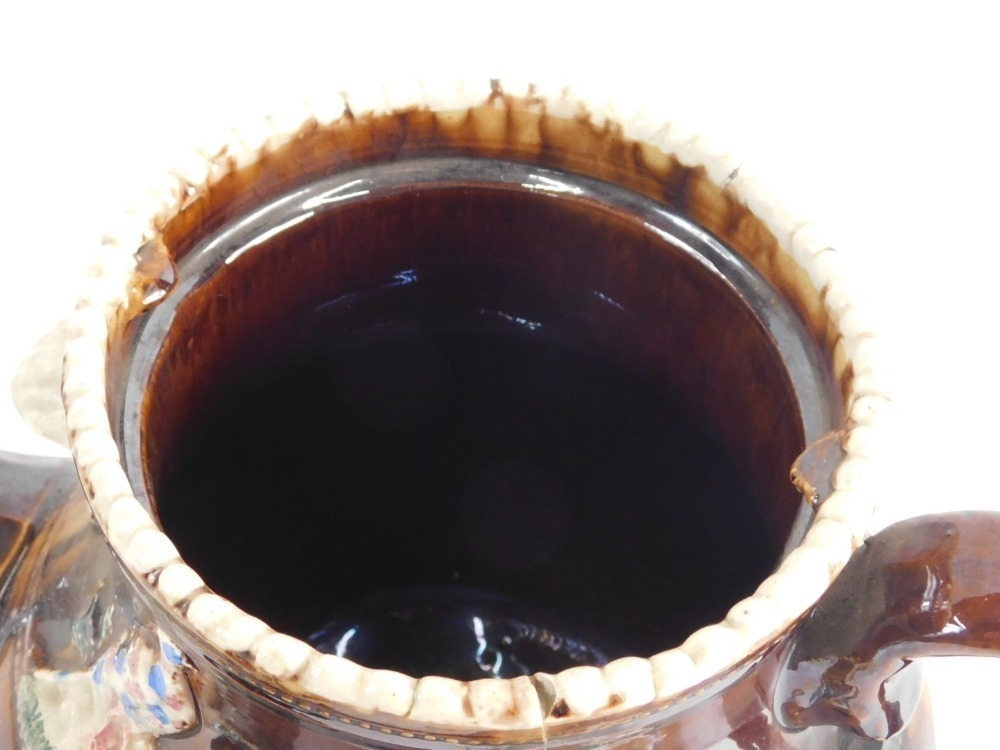 A Bargeware treacle glazed pottery teapot, with teapot knop, raised ...