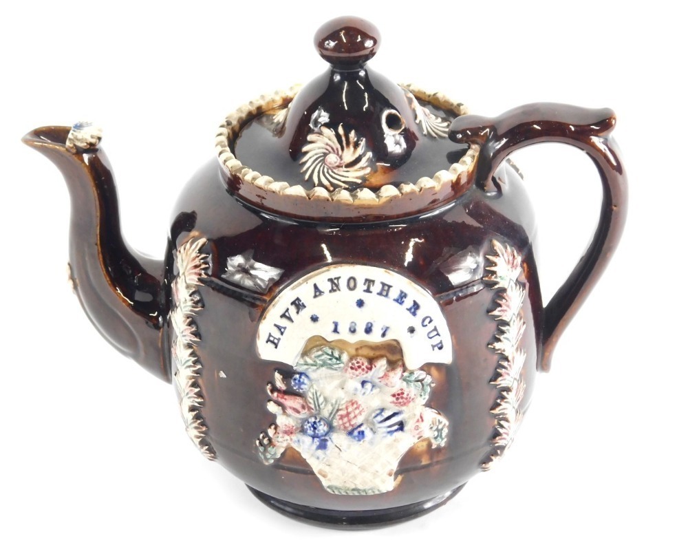 A Bargeware treacle glazed pottery teapot and cover, the body raised ...