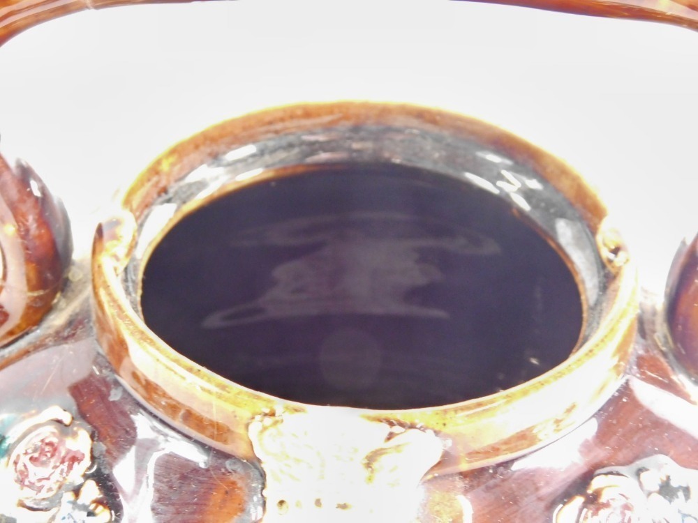 A Bargeware pottery treacle glazed kettle, with shaped handle, raised ...