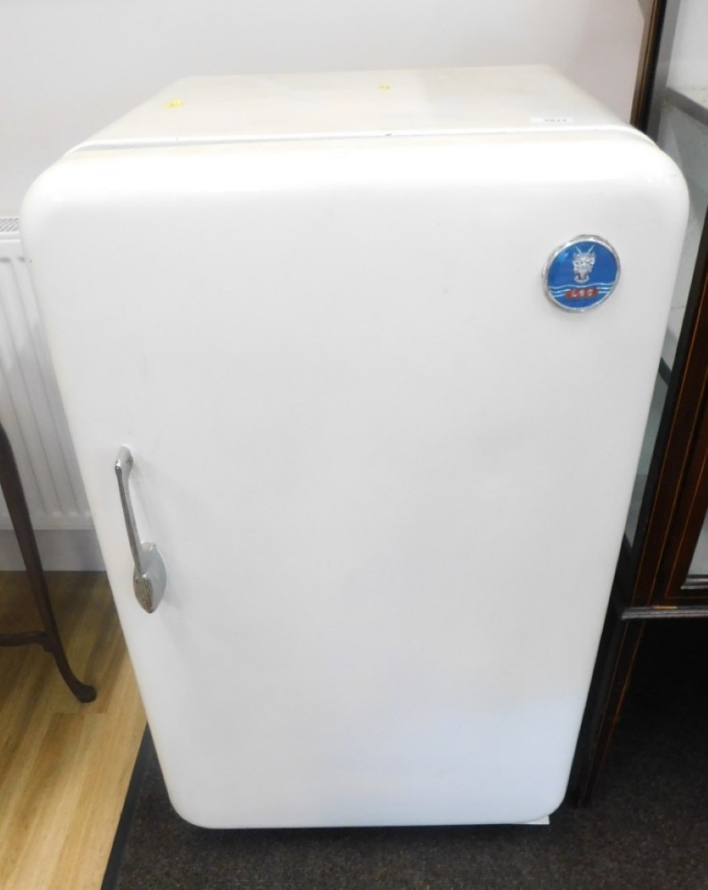 A vintage LEC fridge, in white with raised blue medallion and part ...