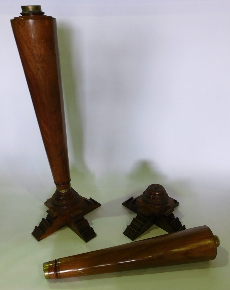 A pair of Continental walnut columns, each with a cross shaped ...