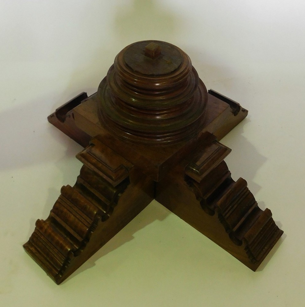 A pair of Continental walnut columns, each with a cross shaped ...