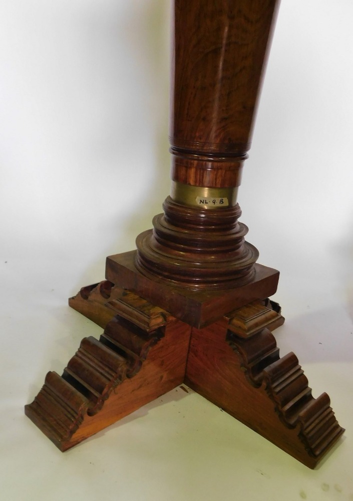 A pair of Continental walnut columns, each with a cross shaped ...