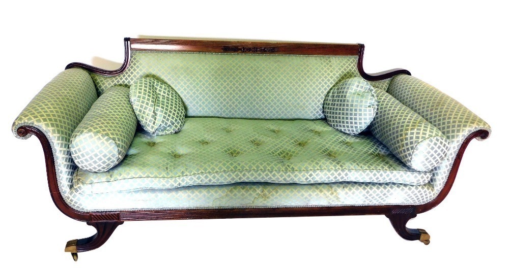 A Regency style mahogany sofa, in green upholstery, with straight ...