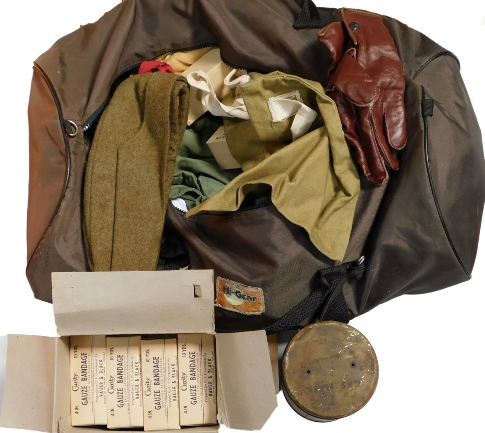 A quantity of militaria, to include gas mask tin, gas mask bag, side ...
