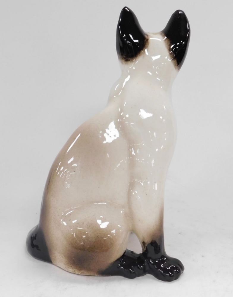 A Winstanley pottery figure of a Siamese cat, modelled in seated pose ...