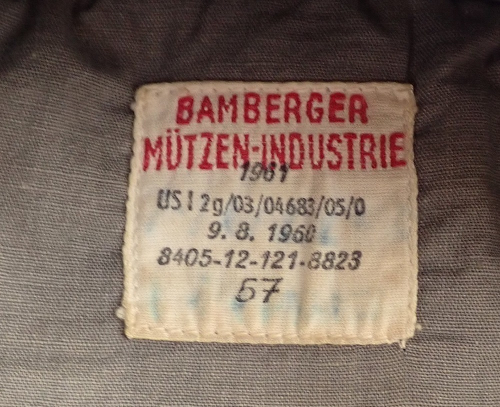 World War II German officer's blue peak cap, a green peak cap with ...