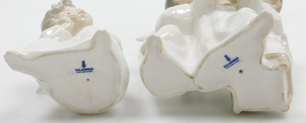 A Lladro porcelain figure of three cherubs, singing from a music sheet ...