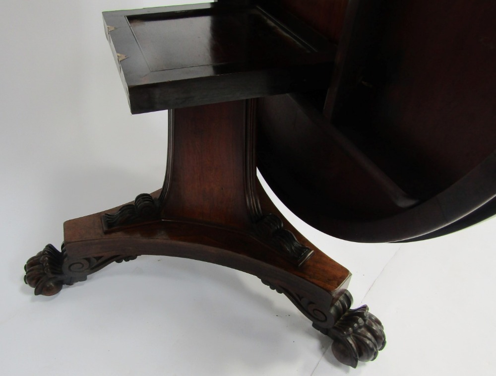 A William IV rosewood circular breakfast table, the tilt top above a ...