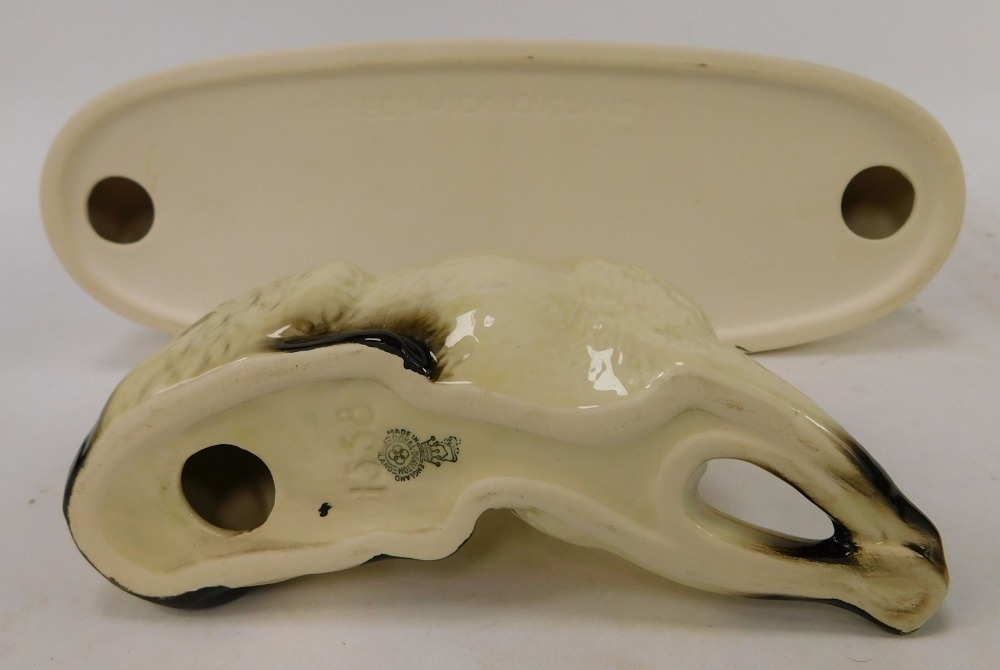 A Beswick matt porcelain figure of The Spaniel, mounted on an oval ...