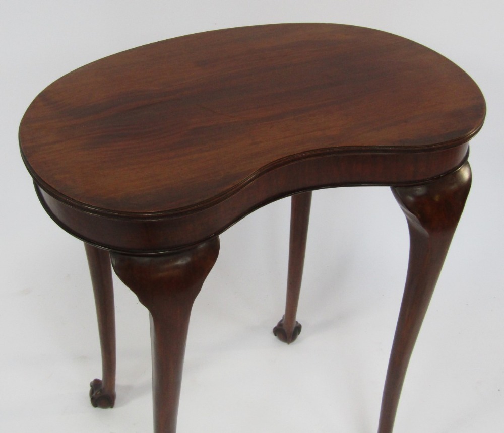 A 20thC mahogany kidney shaped side table, the top with a moulded edge ...