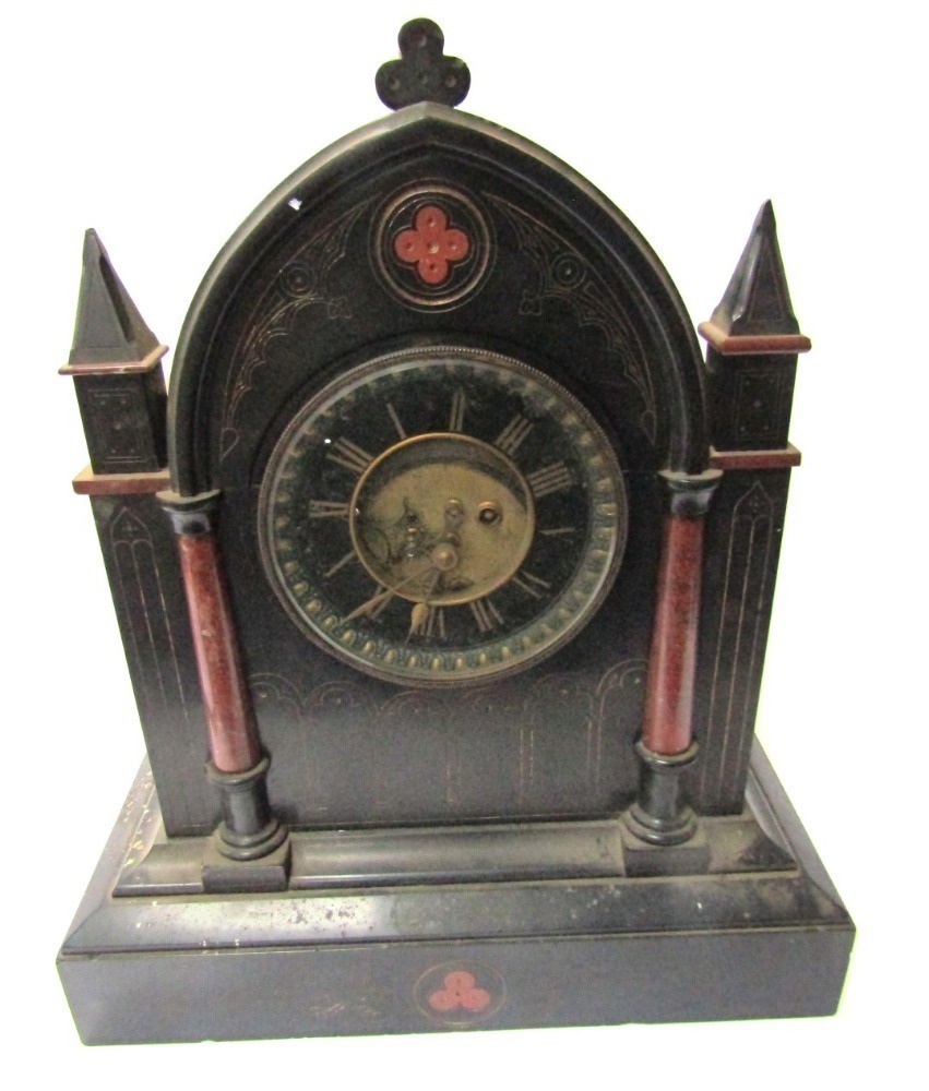 A late 19thC black slate Gothic Revival mantel clock, with an arched ...