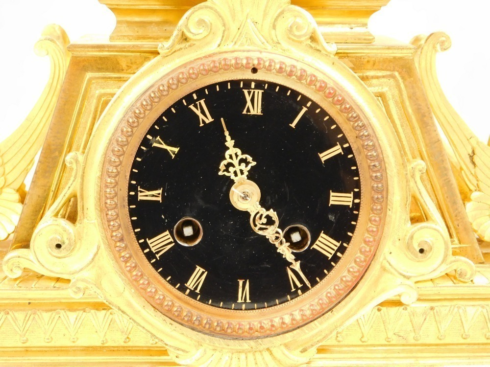 A 19thC French ormolu mantel clock, urn finial, with swan and lion mask ...