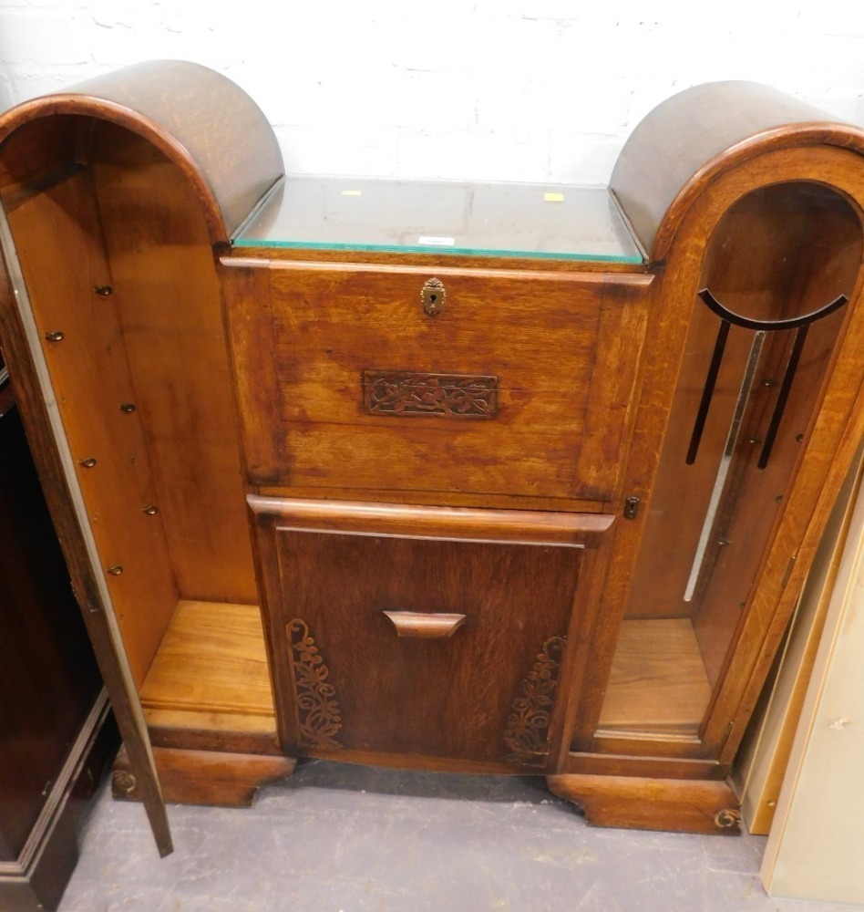 A 1950s oak bureau bookcase, with two arched pillars each with a glass ...