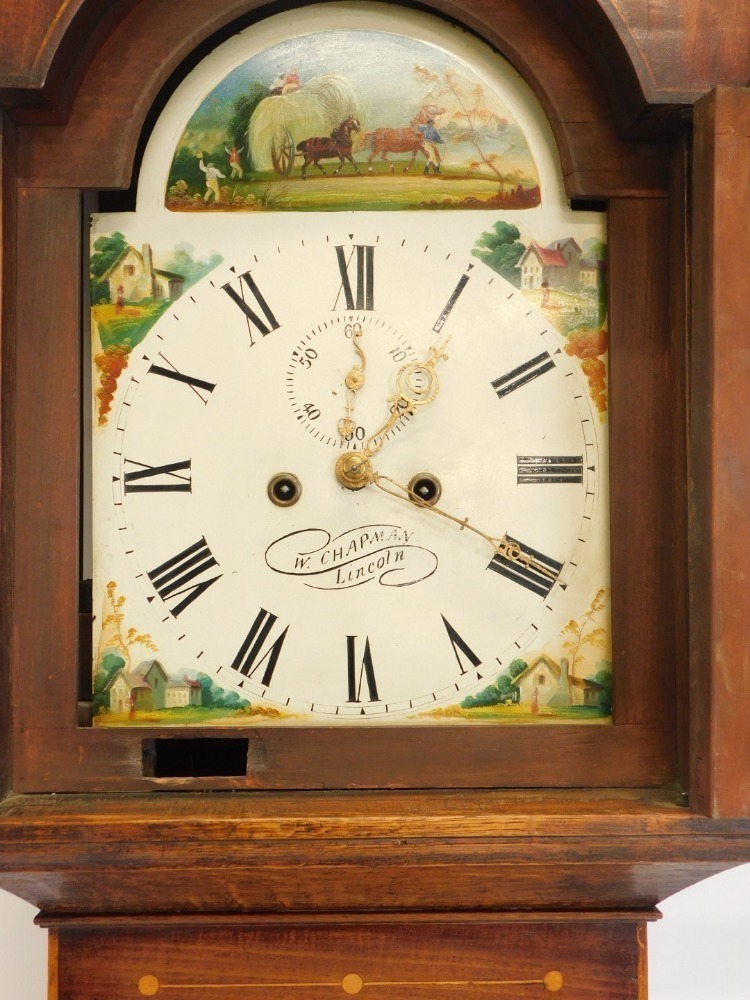 A 19thC longcase clock by W Chapman of Lincoln, the arched painted dial ...
