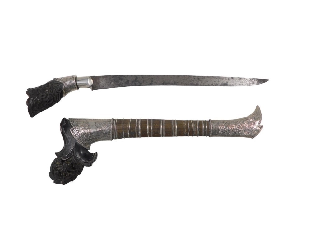 A Malay Sawar white metal mounted dagger, with carved horn handle and ...