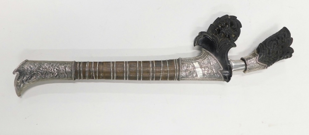 A Malay Sawar white metal mounted dagger, with carved horn handle and ...
