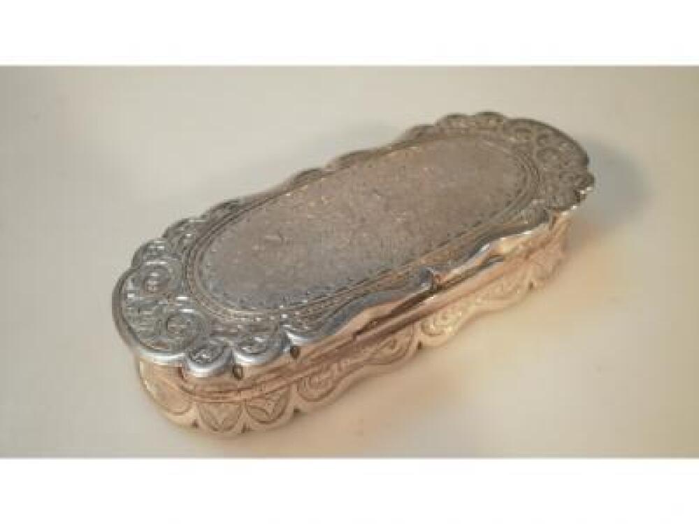 A Victorian silver oval snuff box inscribed ' presented to Frederick J ...