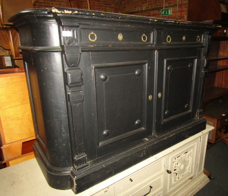 A black painted sideboard, the top with a moulded edge above two ...