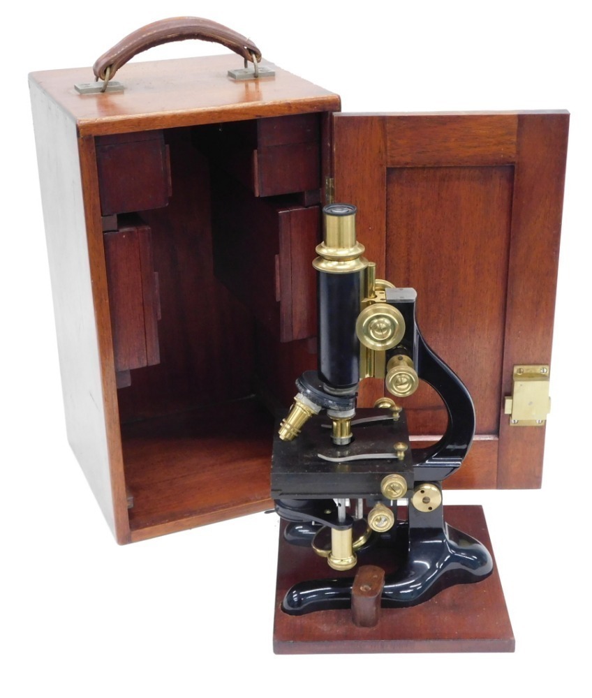 A late 19th/early 20thC brass and ebonised microscope, one lens stamped ...