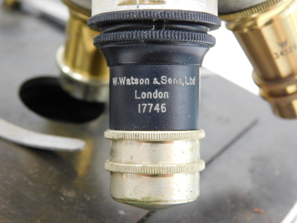 A late 19th/early 20thC brass and ebonised microscope, one lens stamped ...