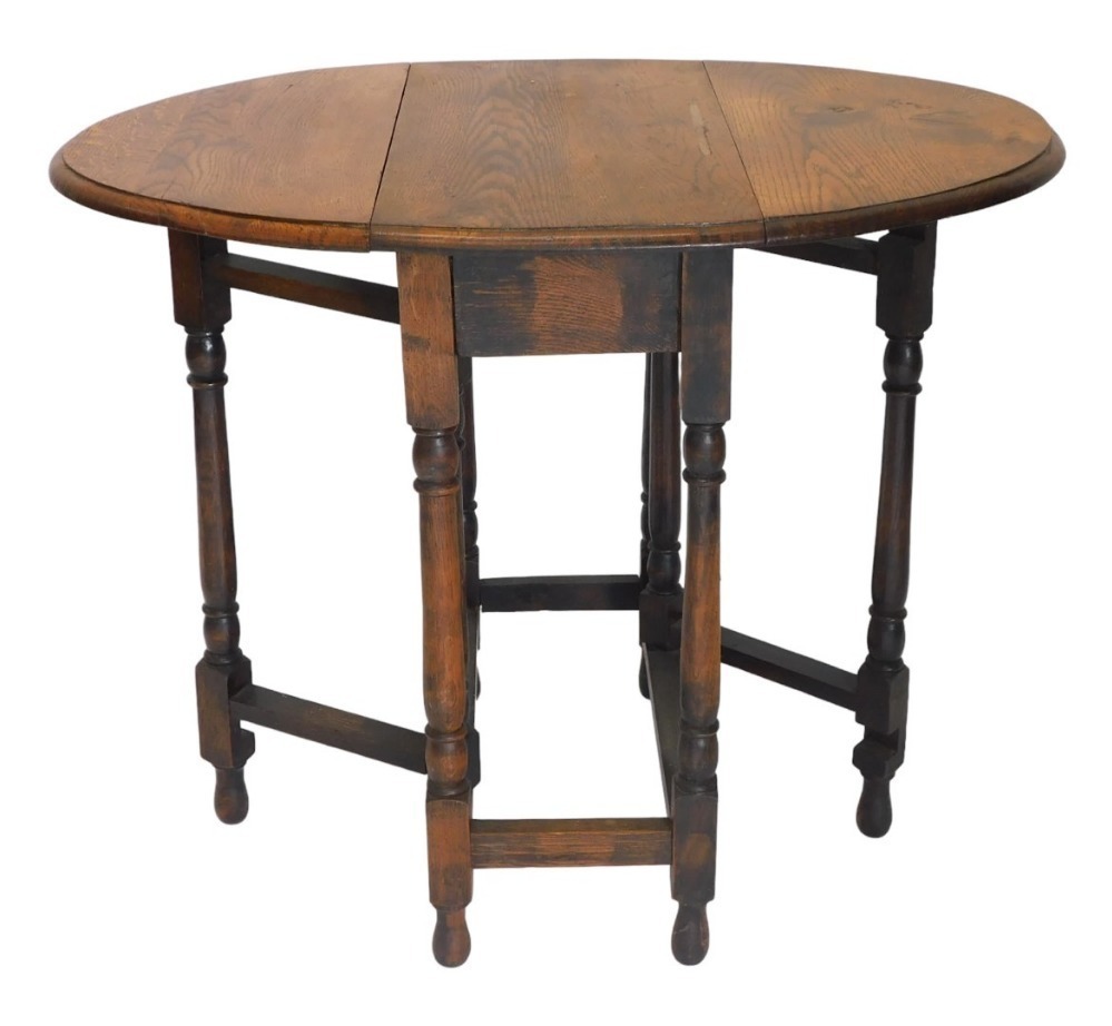 A small oak drop leaf table, the oval top with a moulded edge, on ...