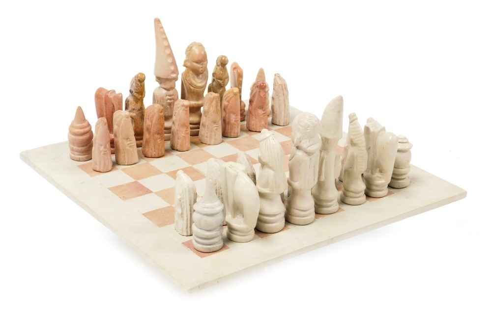 A small soapstone chess board with chess pieces, size of board 25.5cm x ...