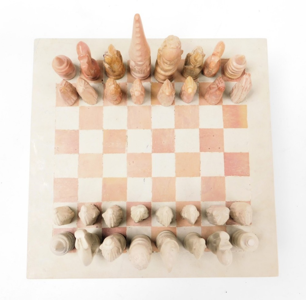 A small soapstone chess board with chess pieces, size of board 25.5cm x ...