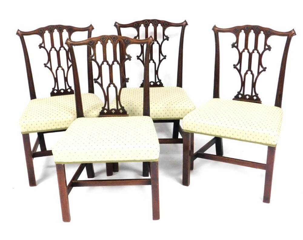 A set of four George III mahogany dining chairs, with Gothic carved ...