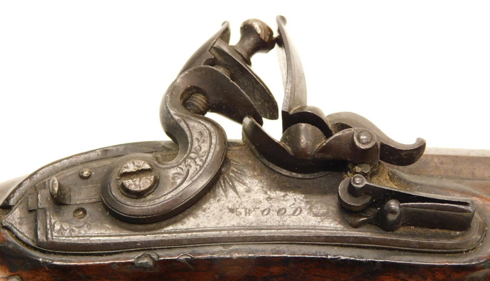 An early 18thC flintlock pistol by Wood, with octagonal barrel, with ...