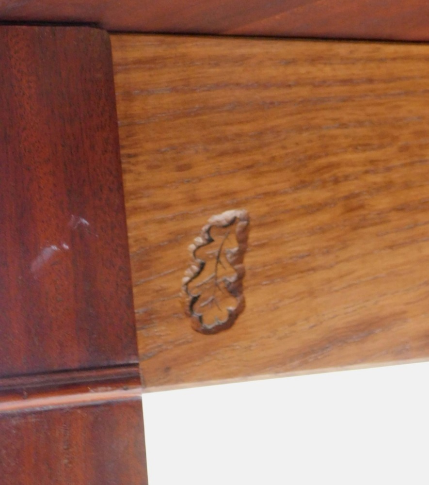 A mahogany oval drop leaf table, with a cross banded border and a ...