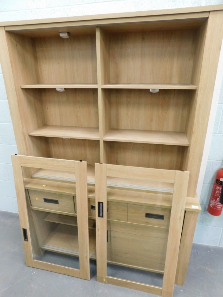 A beech finish display cabinet, with bookshelf and lighted top, above ...