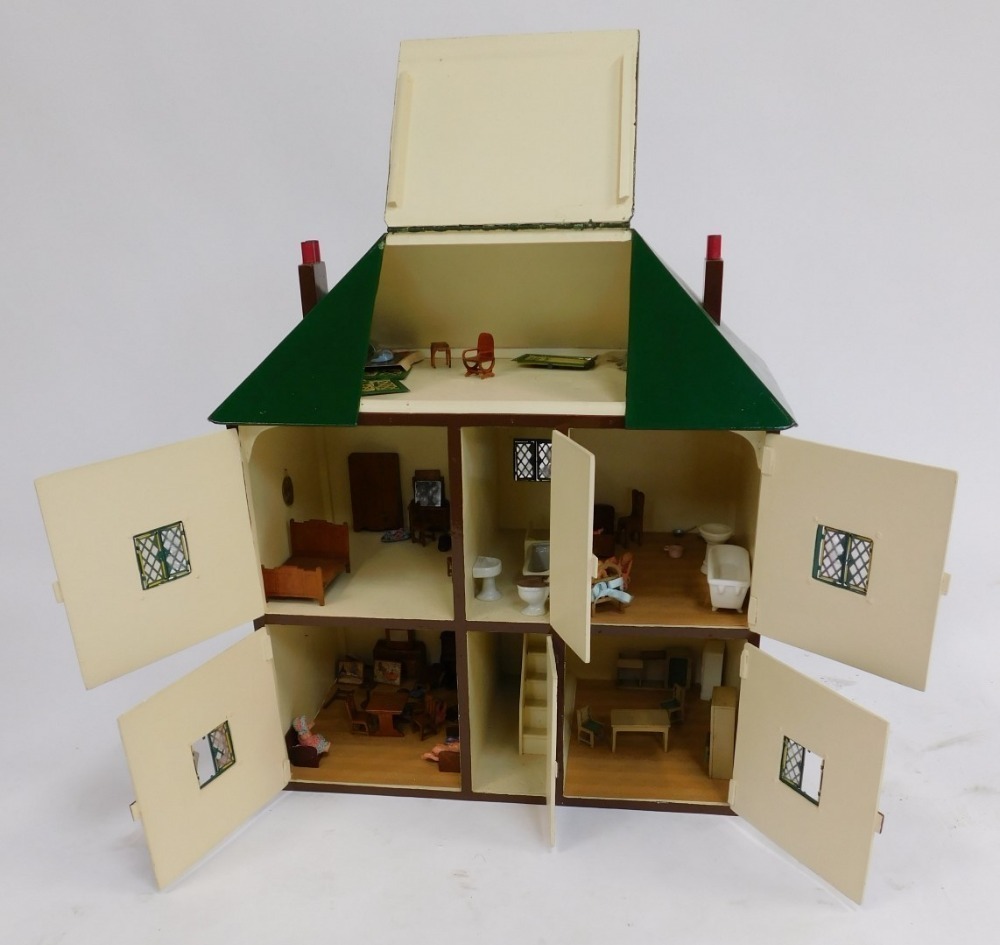A painted wooden two storey dolls house, in brown and cream, with green ...