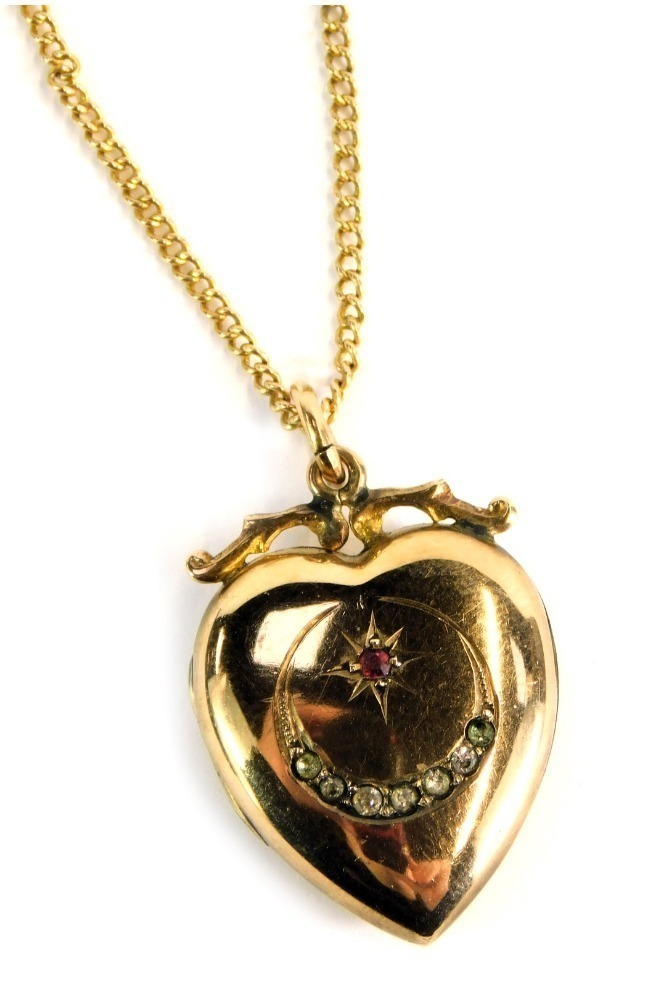 An Edwardian heart shaped locket, set with red and white paste stones ...