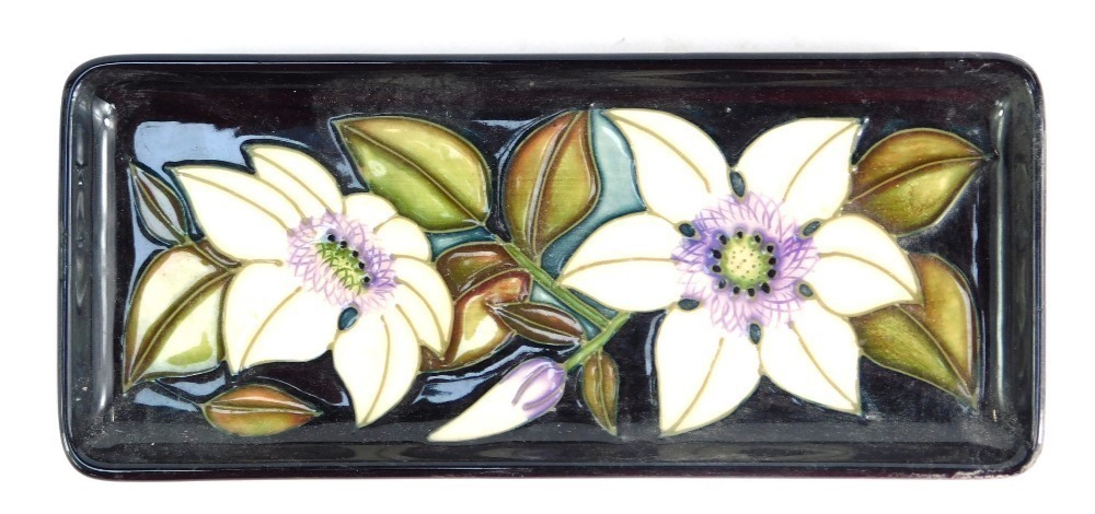 A Moorcroft pottery rectangular pin tray, decorated with flowers ...