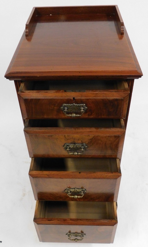 An Edwardian figured walnut pedestal chest, of four graduated drawers ...