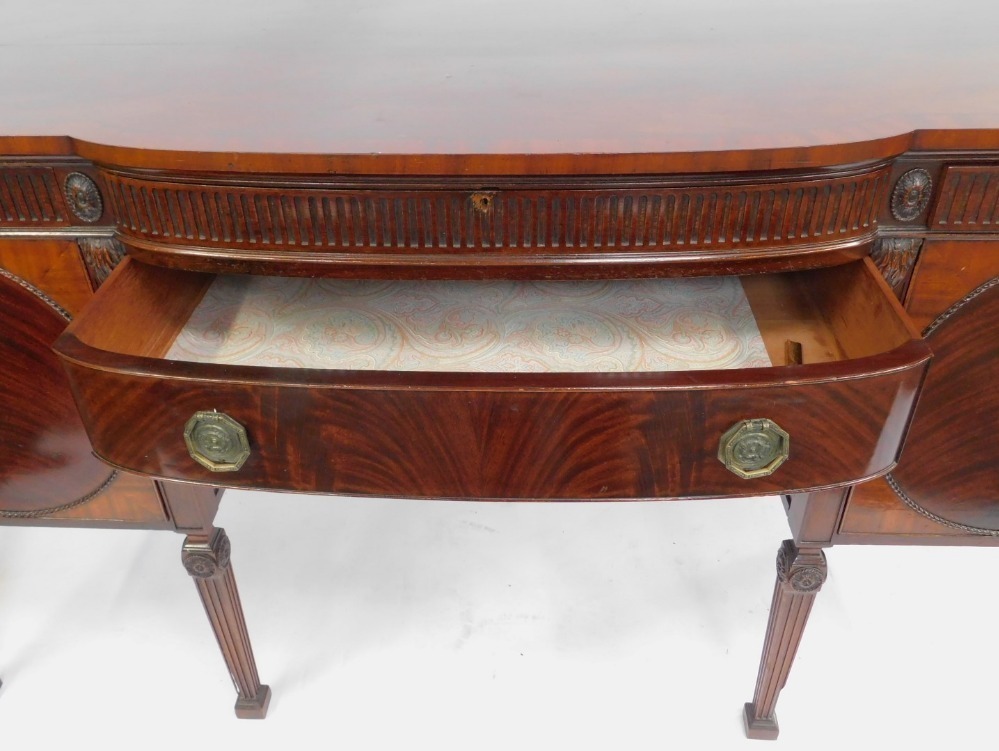 An early 20thC figured and flame mahogany Adam Revival sideboard, with ...