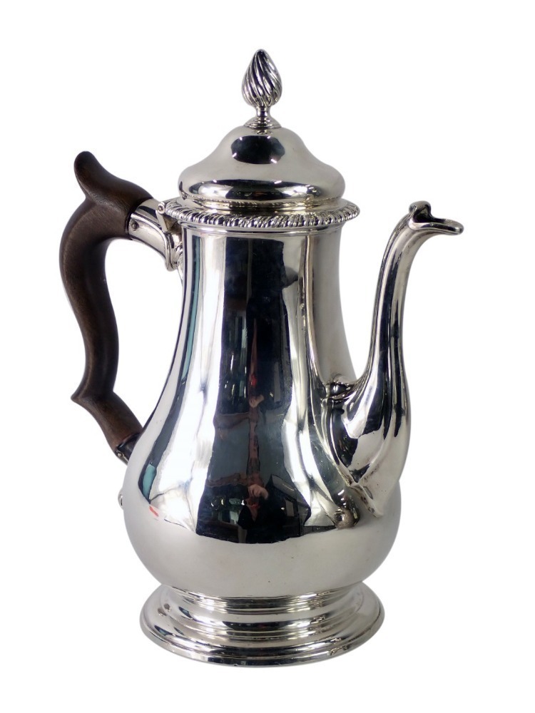 A George III silver coffee pot, with a fluted knop and border, bearing ...