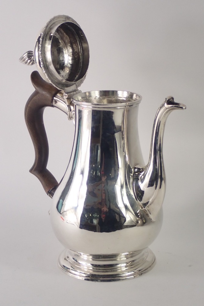 A George III silver coffee pot, with a fluted knop and border, bearing ...