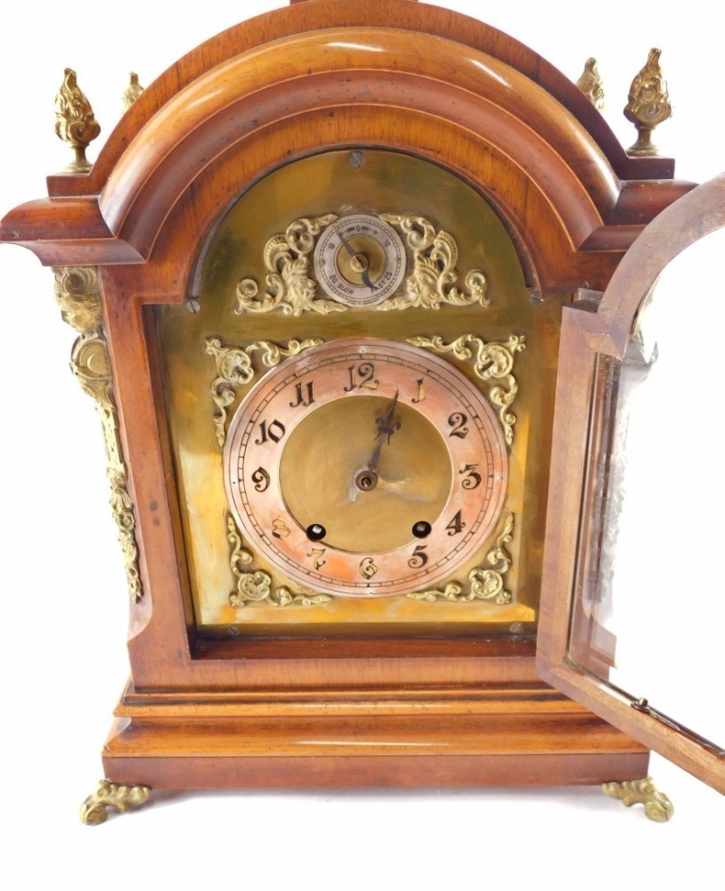 A late 19thC walnut and gilt metal German mantel clock, the top applied ...