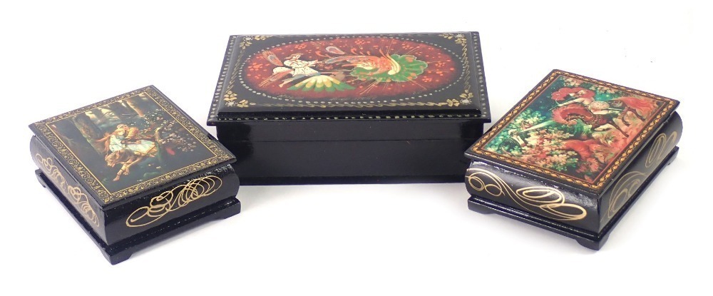 Three Russian black lacquer trinket boxes, decorated with maiden and ...