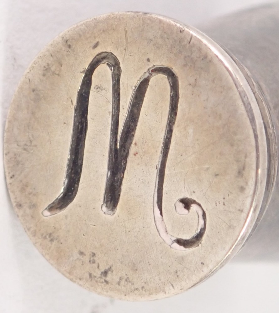 A white metal cased seal, with oval cabochon inset with a cat in basket ...