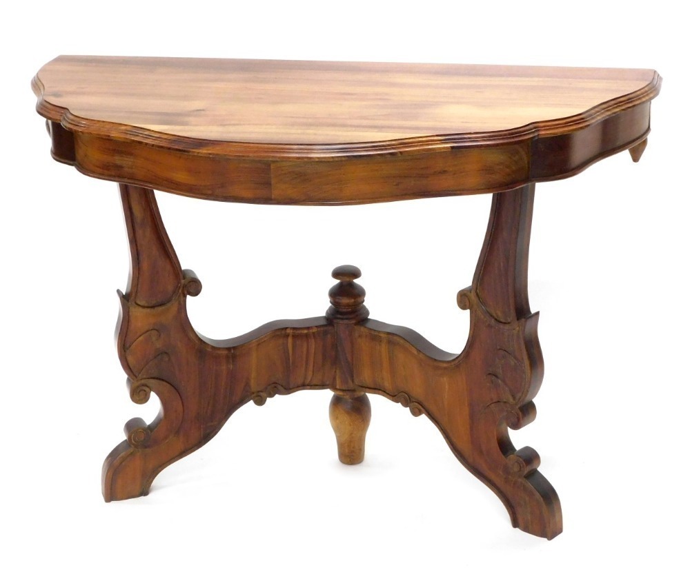 A Continental hardwood console table, the shaped top with a moulded ...