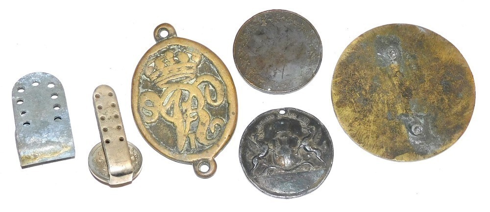 A black pith type fireman's helmet, two collar badges and medallions, a ...