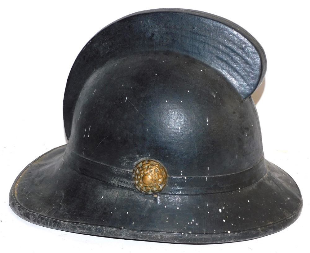 A black pith type fireman's helmet, two collar badges and medallions, a ...