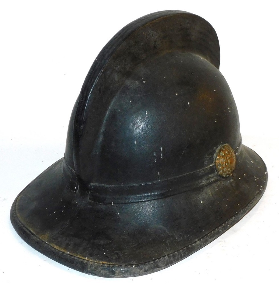 A black pith type fireman's helmet, two collar badges and medallions, a ...