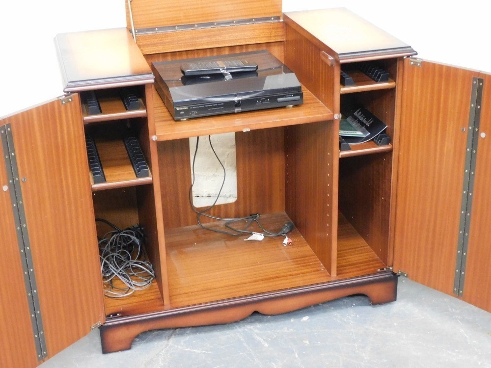 A mahogany veneered music cabinet, with two folding doors to front ...