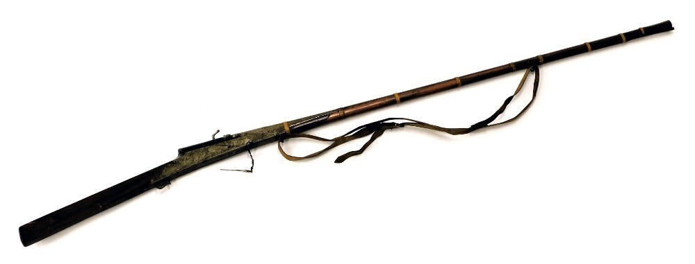 A 19thC Indian matchlock musket, with slightly flared muzzle, ram rod ...
