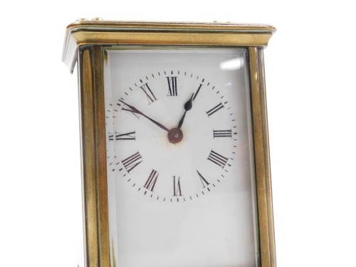 A brass cased carriage clock, rectangular enamel dial bearing Roman numerals, single barrel ...