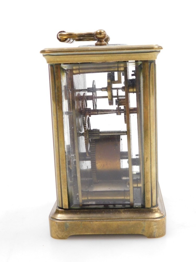 A brass cased carriage clock, rectangular enamel dial bearing Roman numerals, single barrel ...
